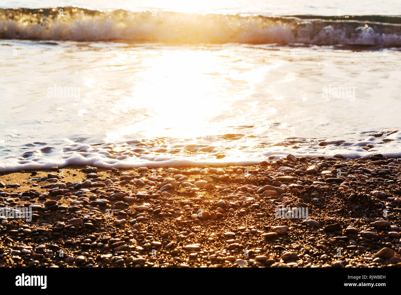 Beautiful sea wave and pebble at sunset. Amazing holiday and travel background Stock Photo - Alamy