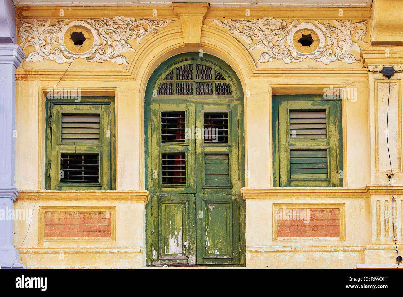 detail of the facade of a old shophouse building in George Town, Penang ...