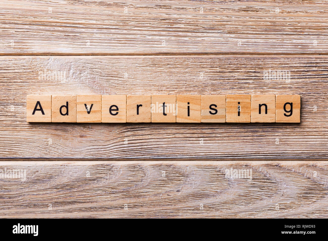ADVERTISING word written on wood block. ADVERTISING text on wooden ...