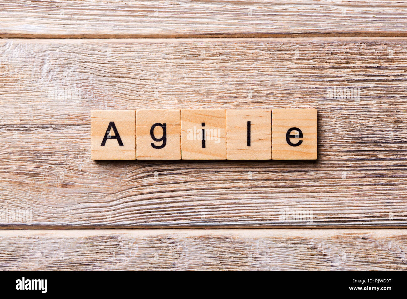 Agile word written on wood block. Agile text on wooden table for your ...