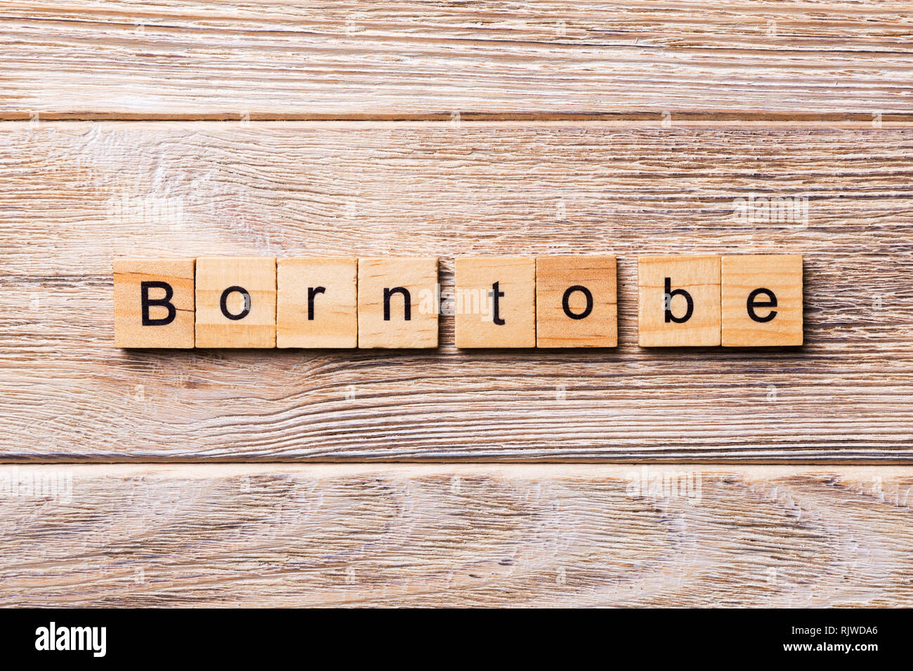 born to be word written on wood block. born to be text on wooden table ...
