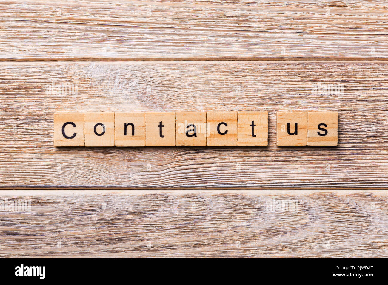 Contact Us word written on wood block. Contact Us text on wooden table ...