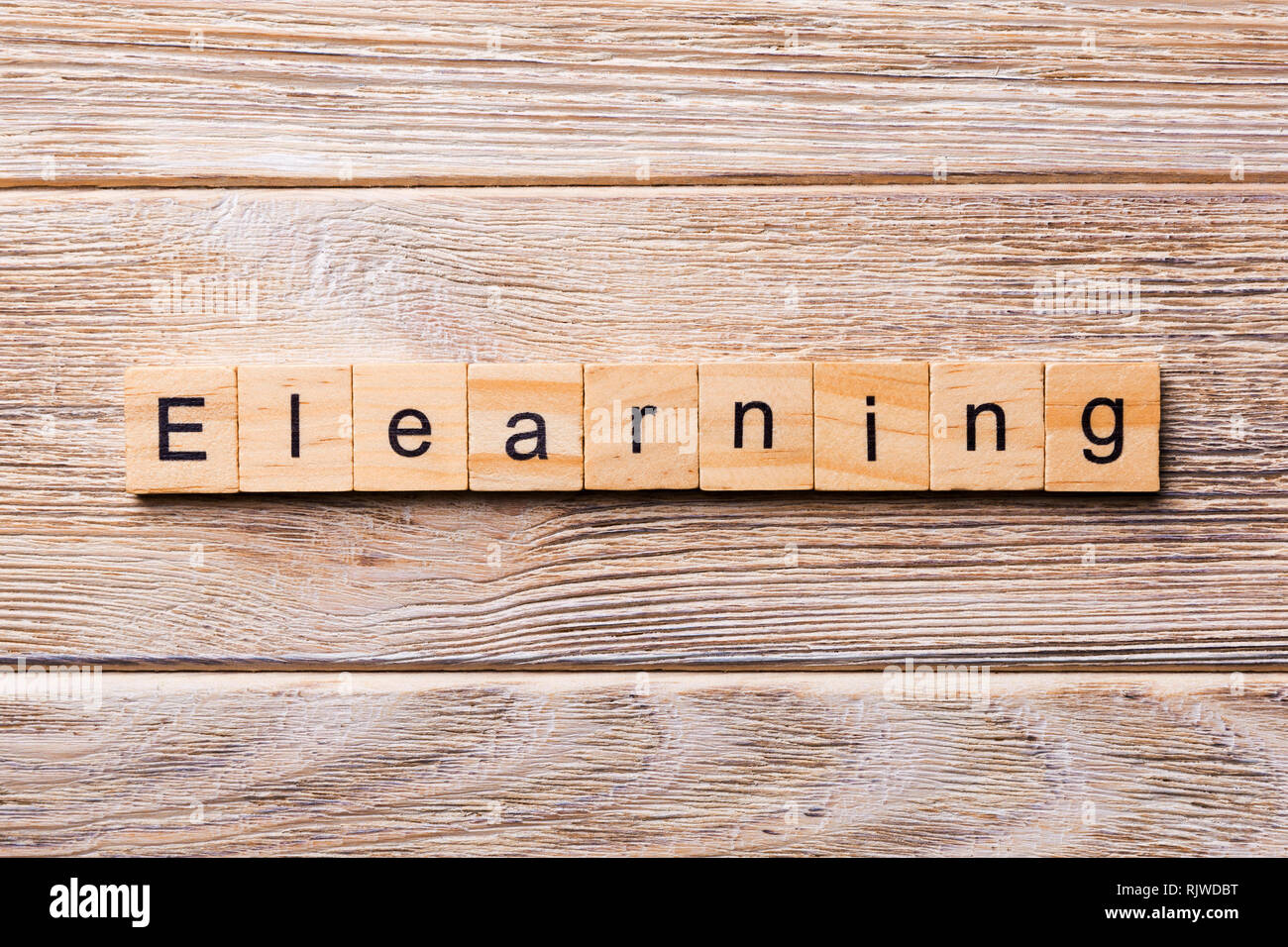 Elearning word written on wood block. Elearning text on wooden table ...