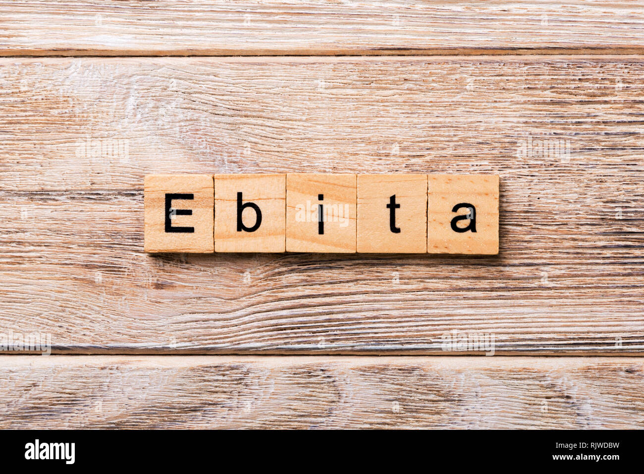 EBITA word written on wood block. EBITA text on wooden table for your ...
