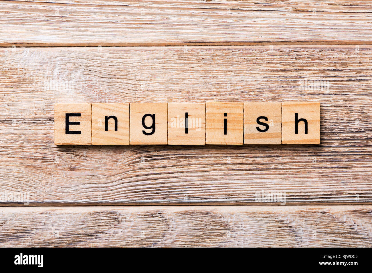 english word written on wood block. english text on wooden table for ...