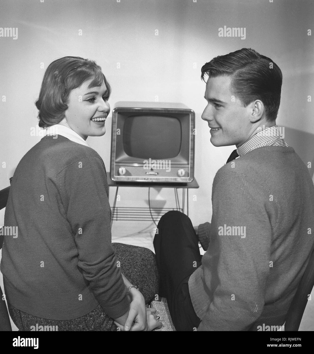 Television in the 1950s. A young couple is pictured sitting in front of ...