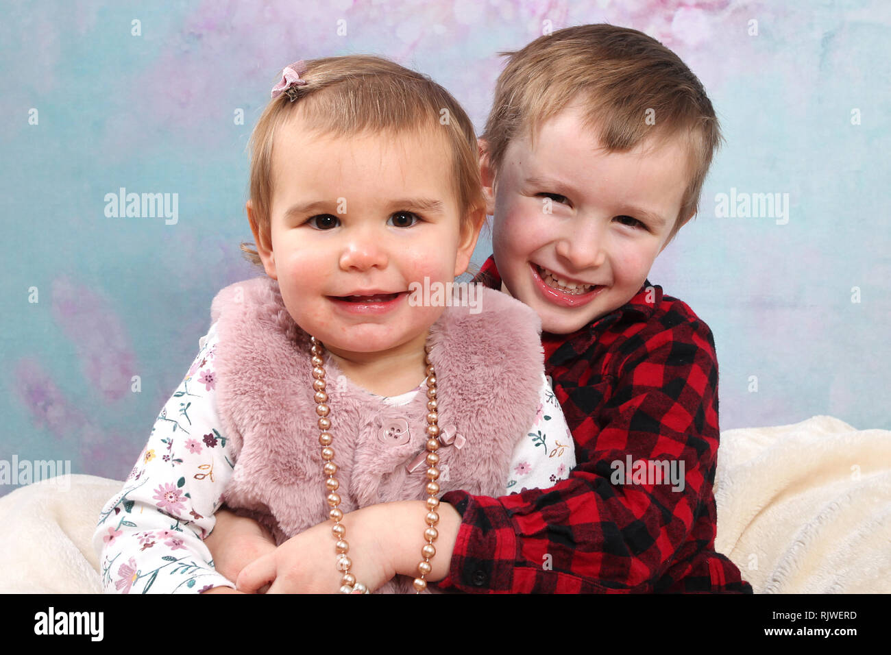 Brother sister cuddling hi-res stock photography and images - Alamy