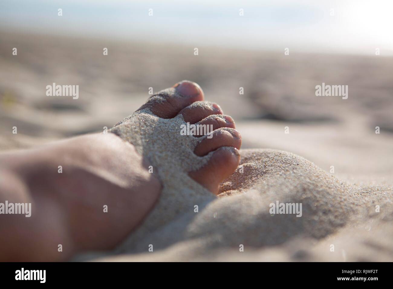 Foot in the sand on the sandy beach, Gurp Plage, Grayan-et-l`Hopital ...