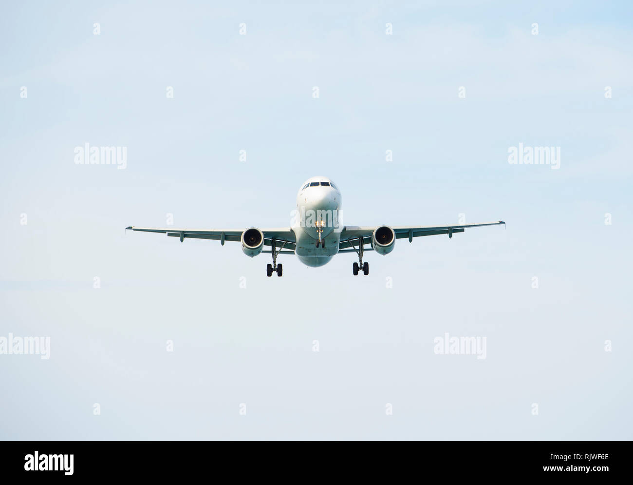 Large airplane front view almost overhead departing or ready to land ...