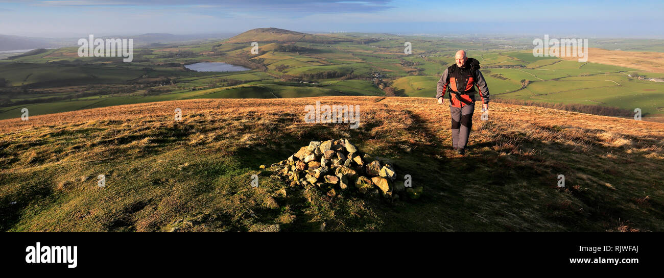 Walker at the Summit cairn on Longlands fell, Lake District National ...
