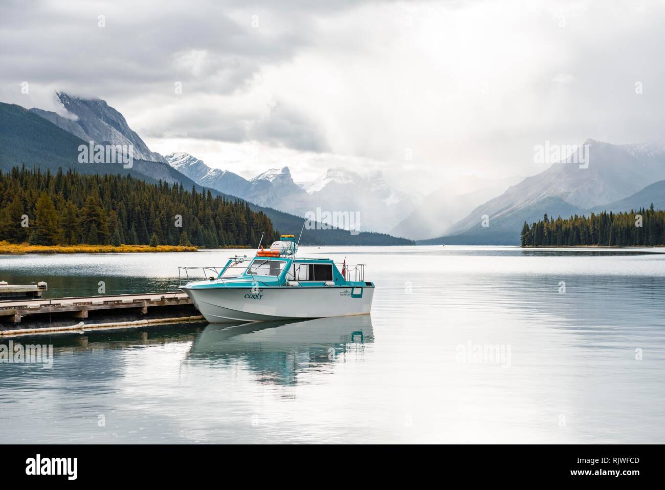 Motorboat moored at the jetty, Maligne Lake, Queen Elizabeth Ranges ...