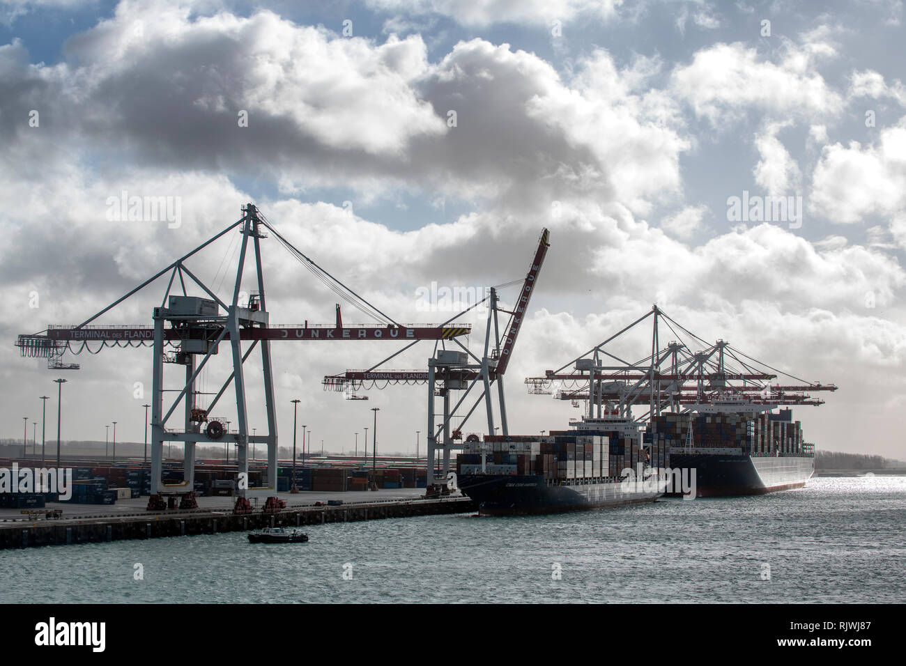 The port of Dunkerque in Northern France. Cranes load container ships ...