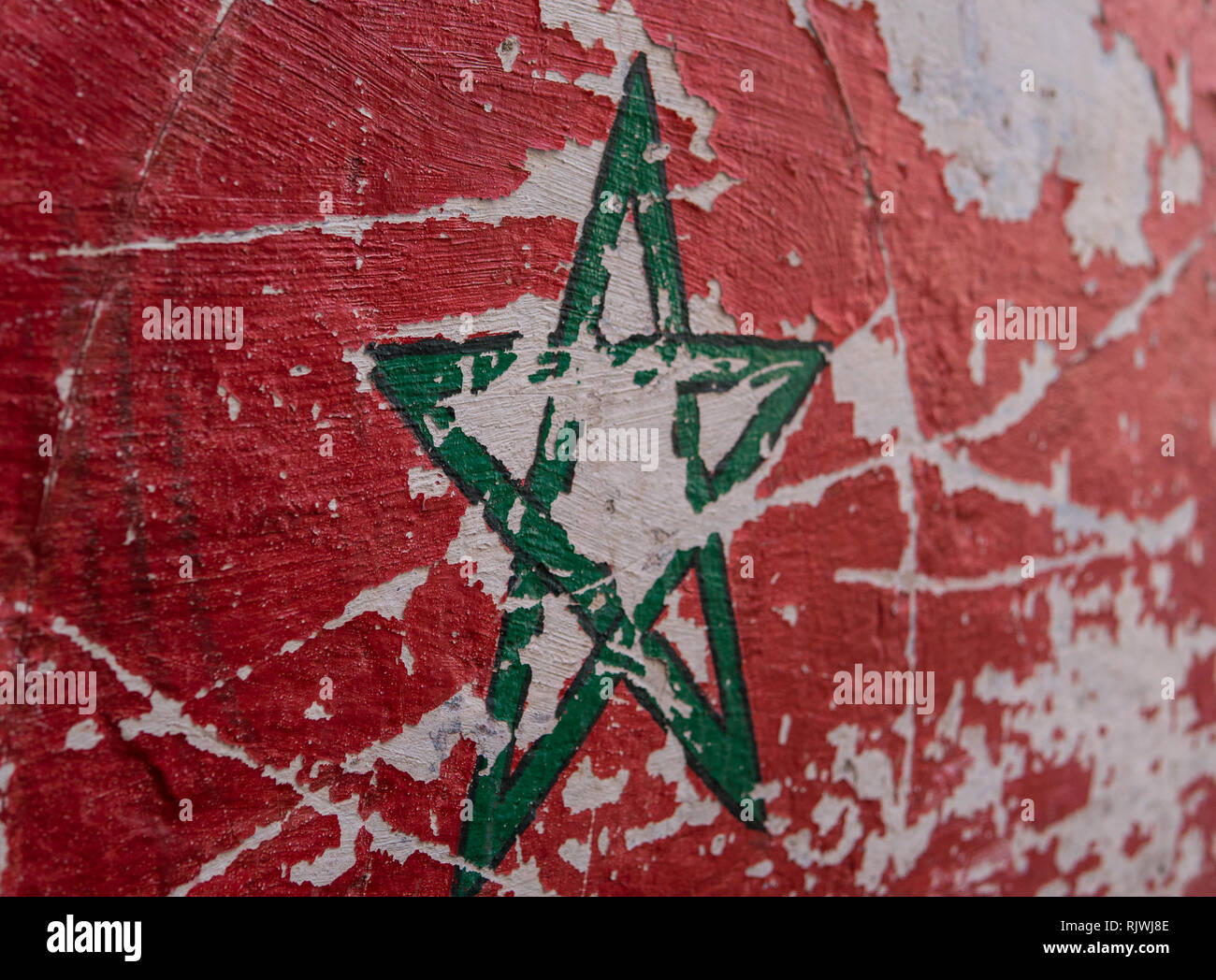 Green star on flag of Morocco on street wall background Stock Photo - Alamy