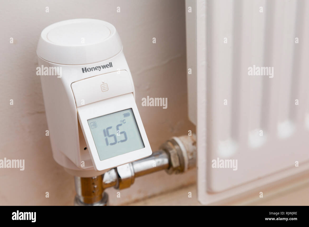 A smart wireless radiator valve attached to a domestic radiator Stock ...
