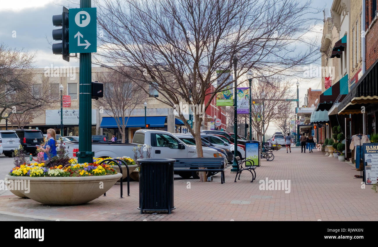 Historic Downtown McKinney, Texas. Colorful flowers in cement planters ...