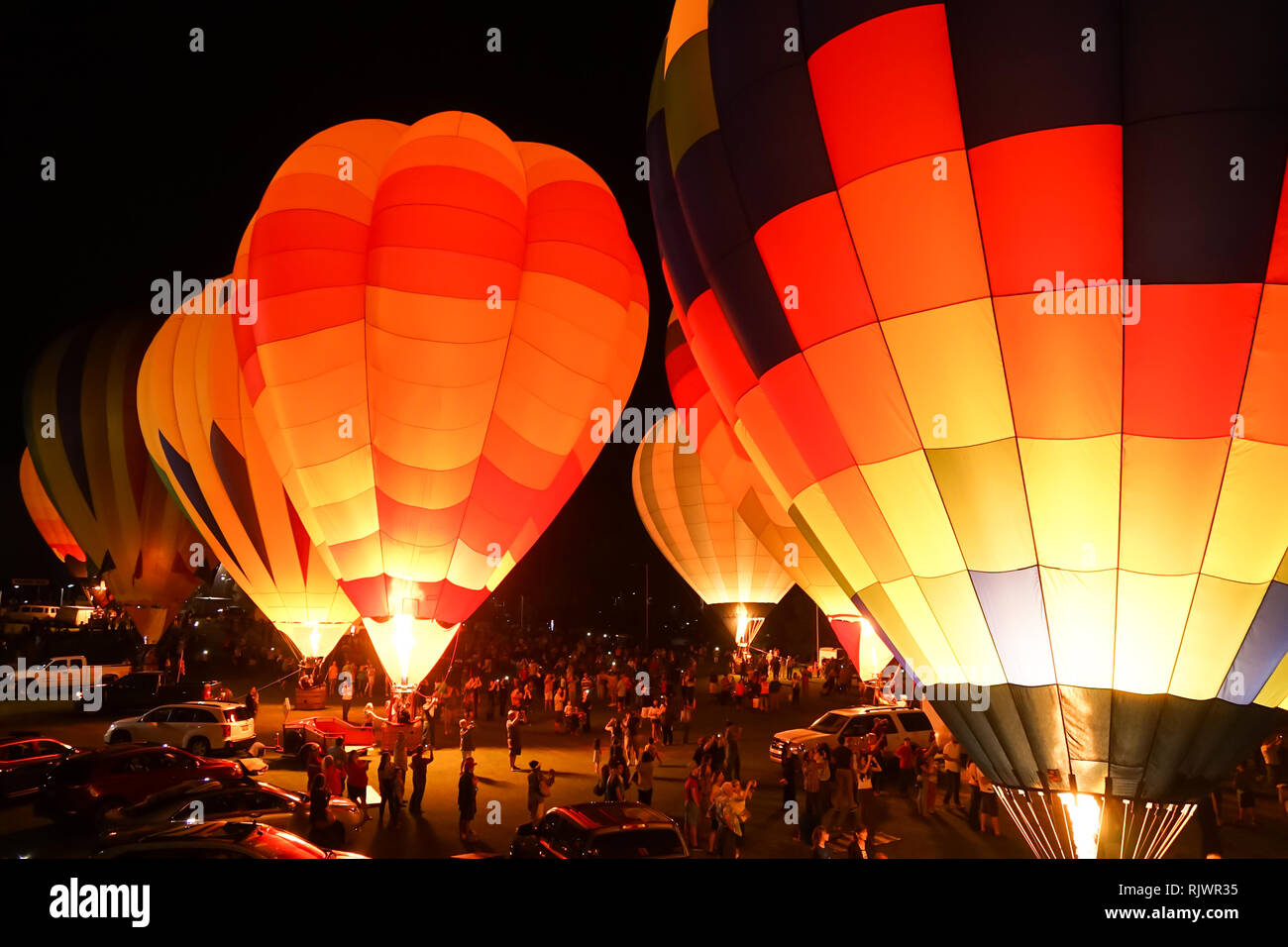 Hot air balloons participate in a night glow, where pilots light up the ...