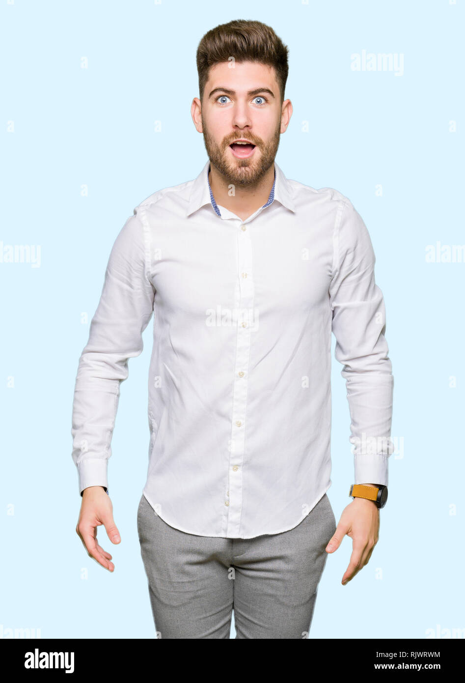 Young handsome business man afraid and shocked with surprise expression ...