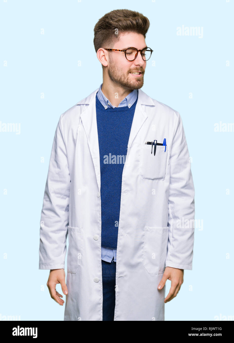 Young handsome scientist man wearing glasses looking away to side with ...