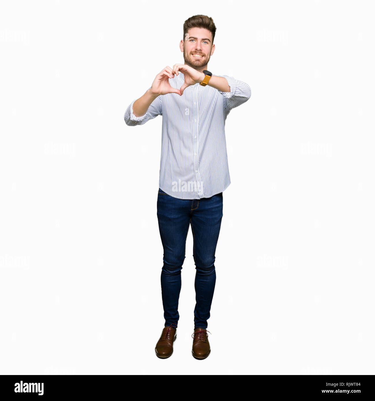 Young handsome man smiling in love showing heart symbol and shape with ...