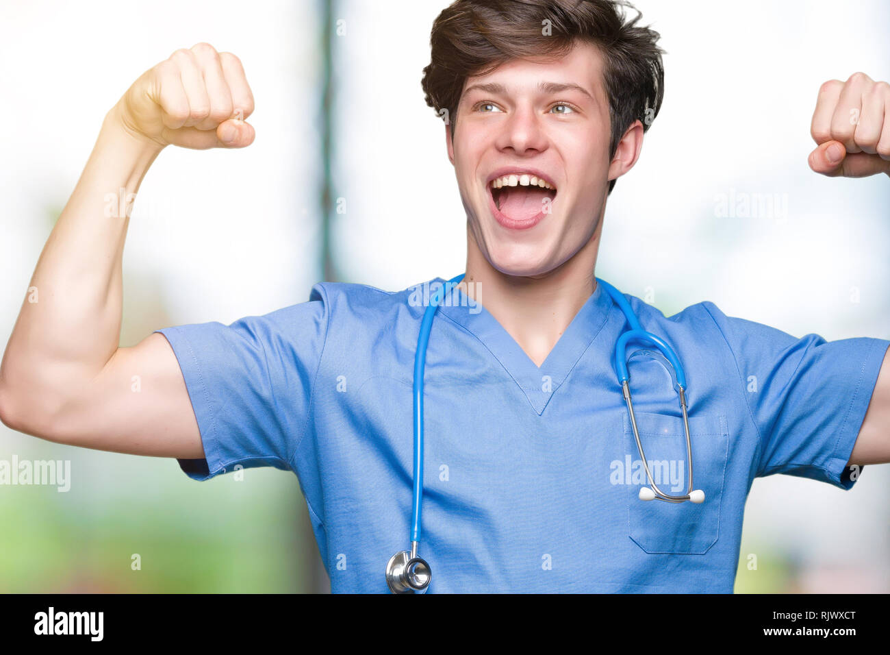 Young doctor wearing medical uniform over isolated background showing ...