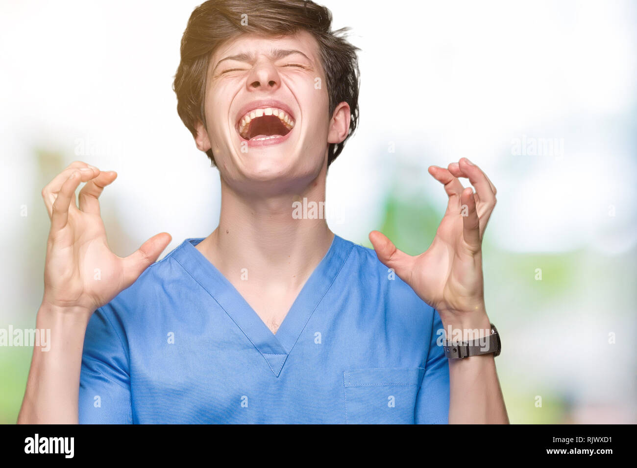 Young doctor wearing medical uniform over isolated background ...
