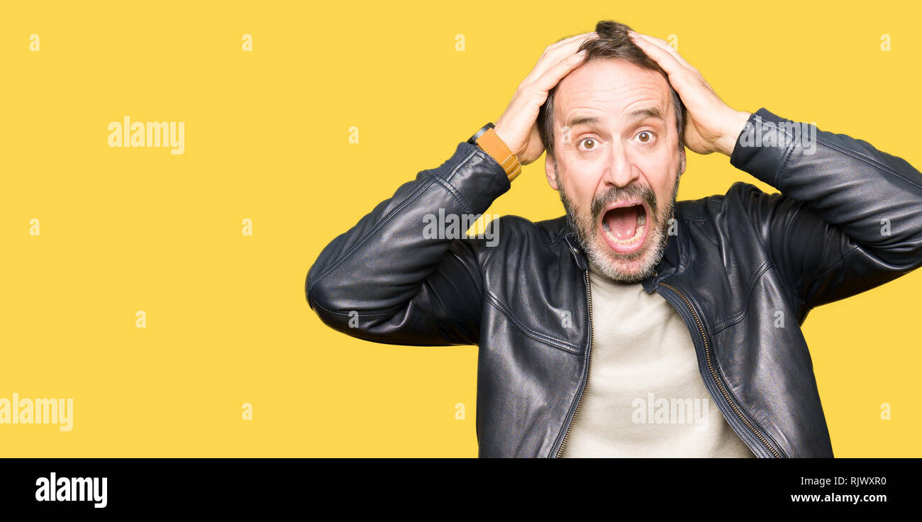 Middle age handsome man wearing black leather jacket Crazy and scared ...