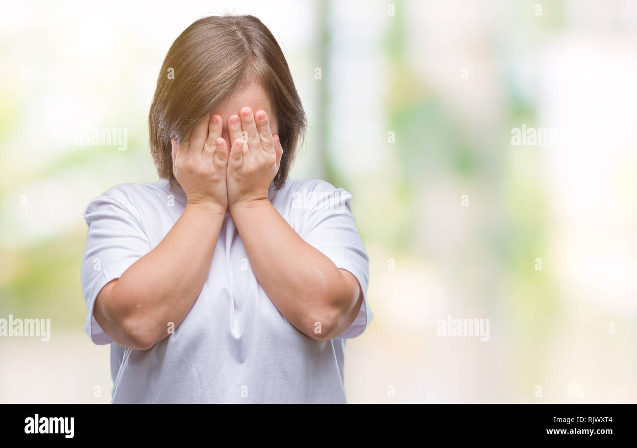 Young adult woman with down syndrome over isolated background with sad ...