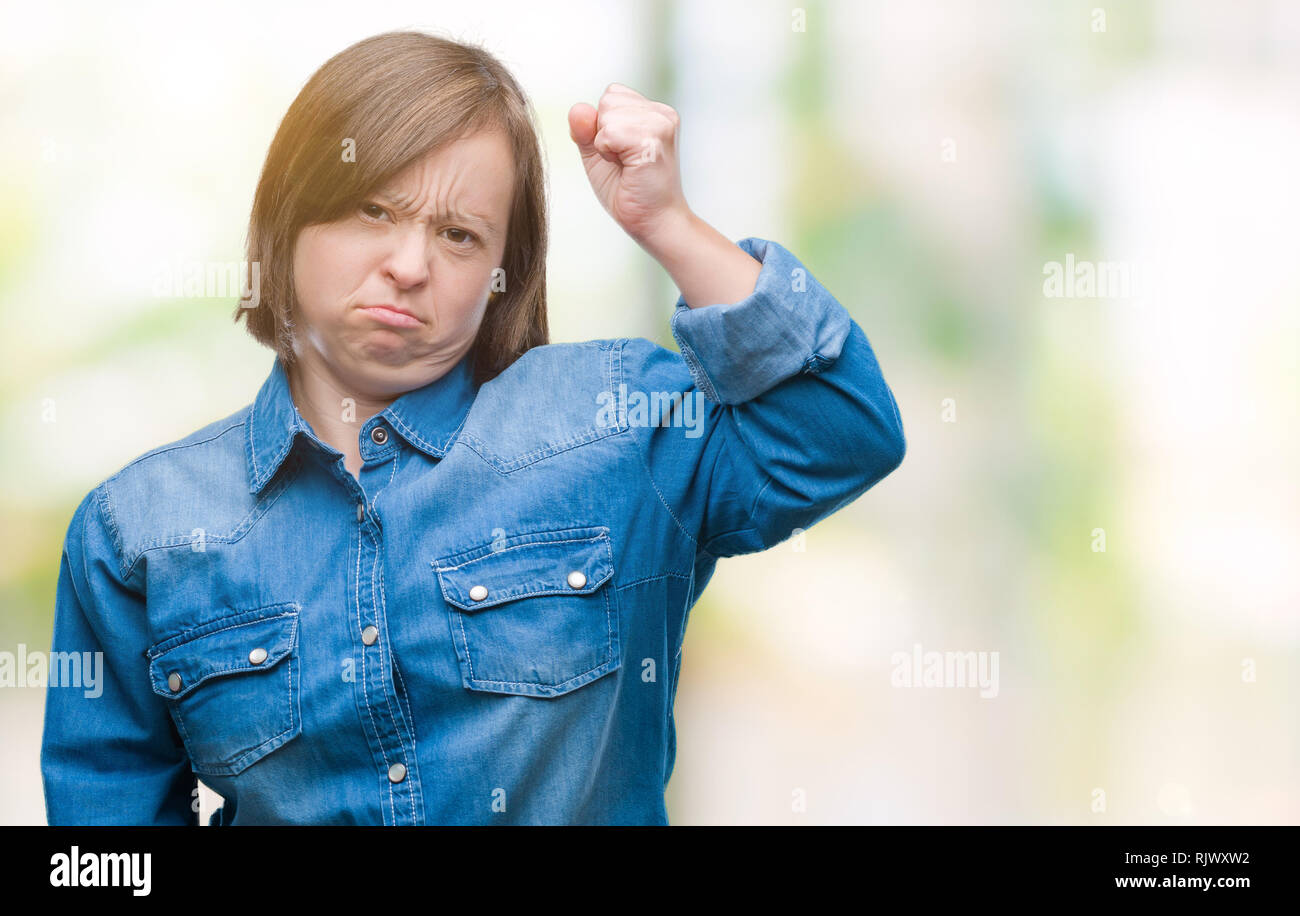 Young adult woman with down syndrome over isolated background angry and ...