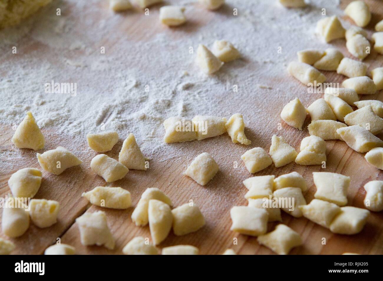 Preparing "halusky" or "kluski" on a cutting board - a traditional ...