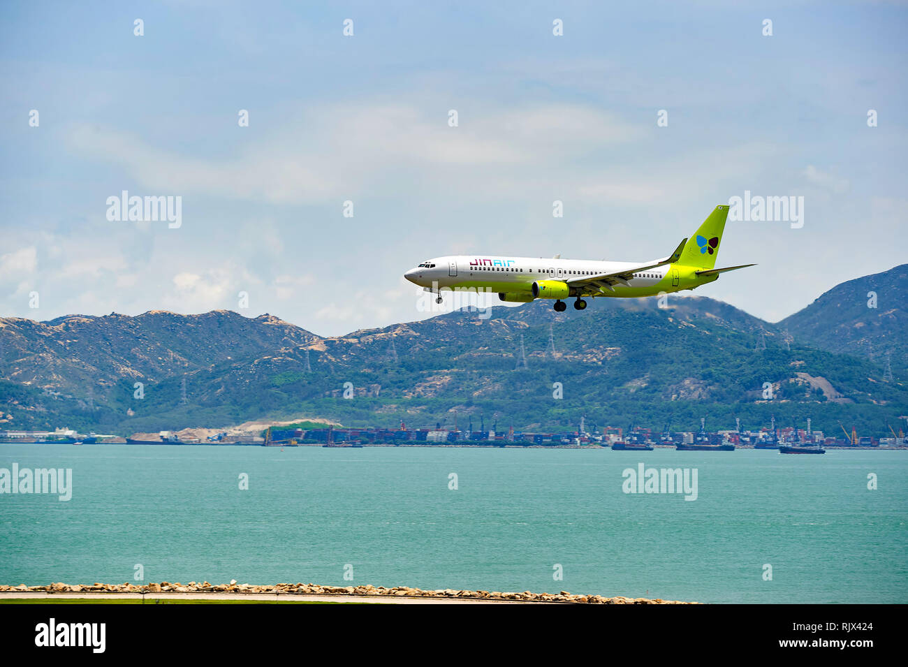 HONG KONG - JUNE 04, 2015: Jin Air aircraft landing at Hong Kong ...