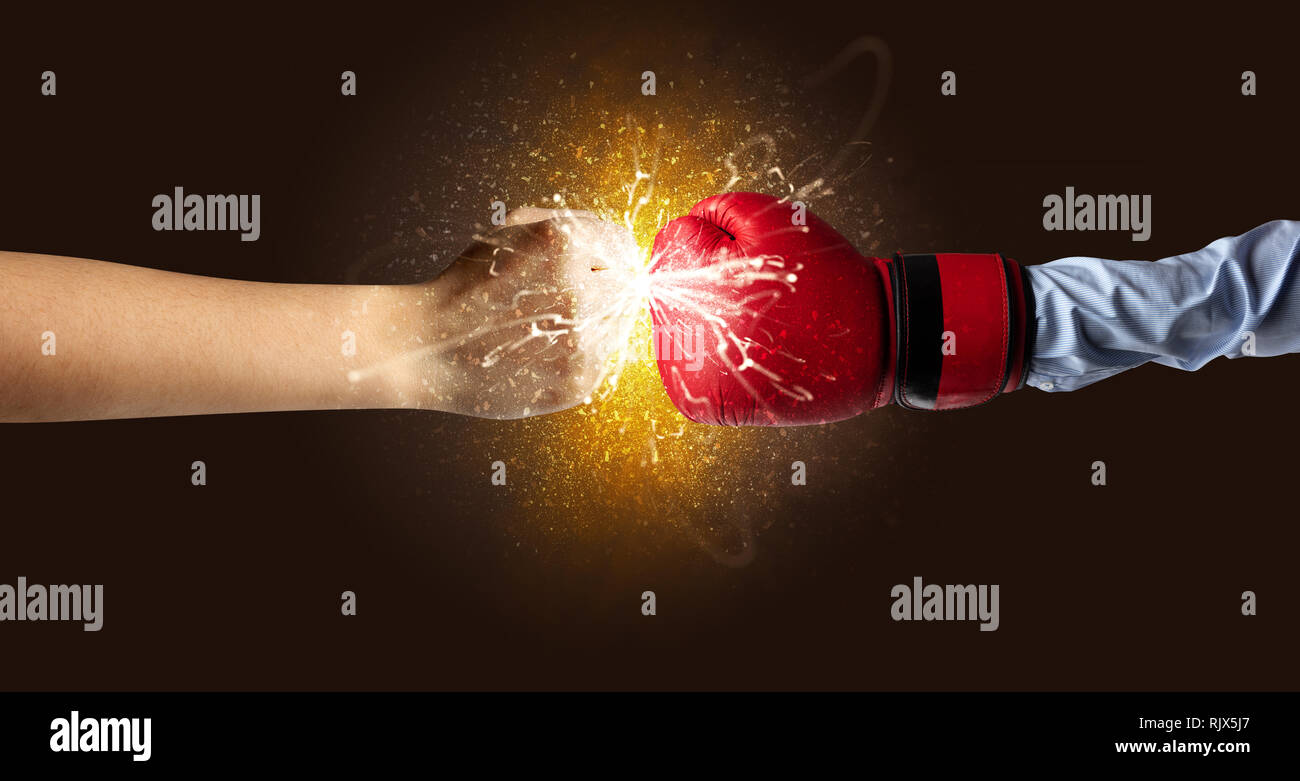 Two hands fighting with orange dust, spark, glow and smoke concept ...