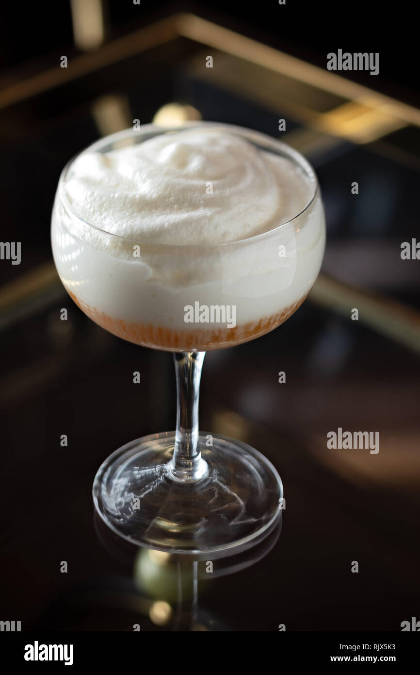 A short and delicious cocktail served in a coupette glass topped up ...