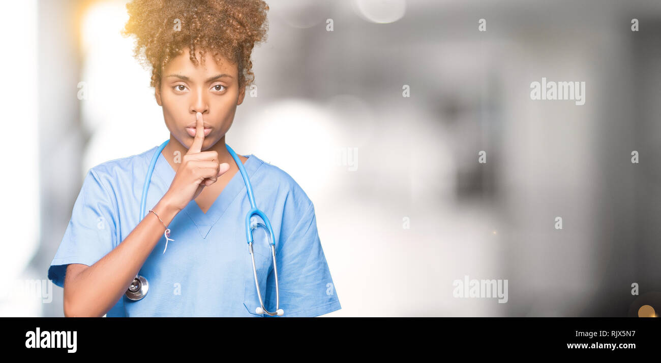 Young african american doctor woman over isolated background asking to ...