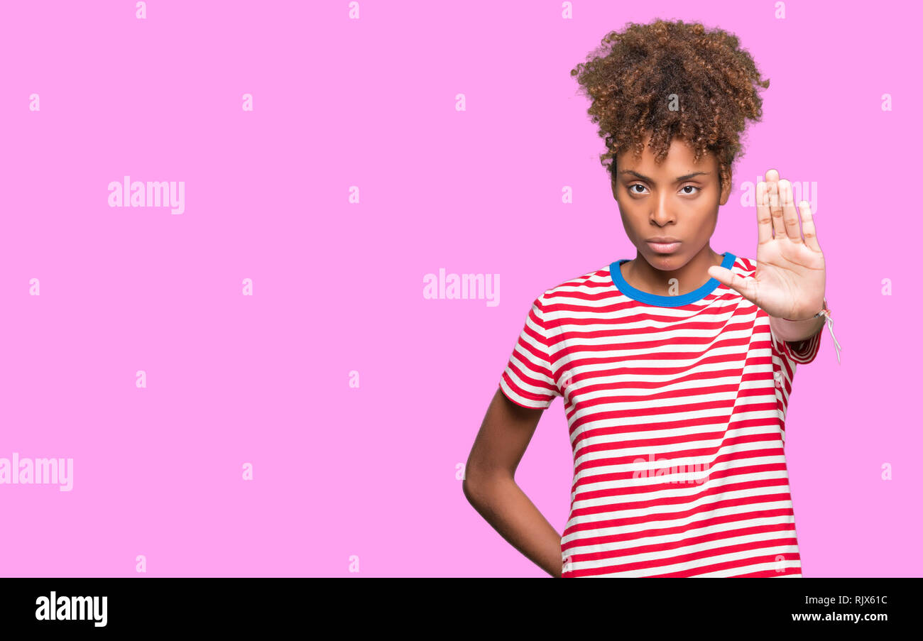 Beautiful young african american woman over isolated background doing ...