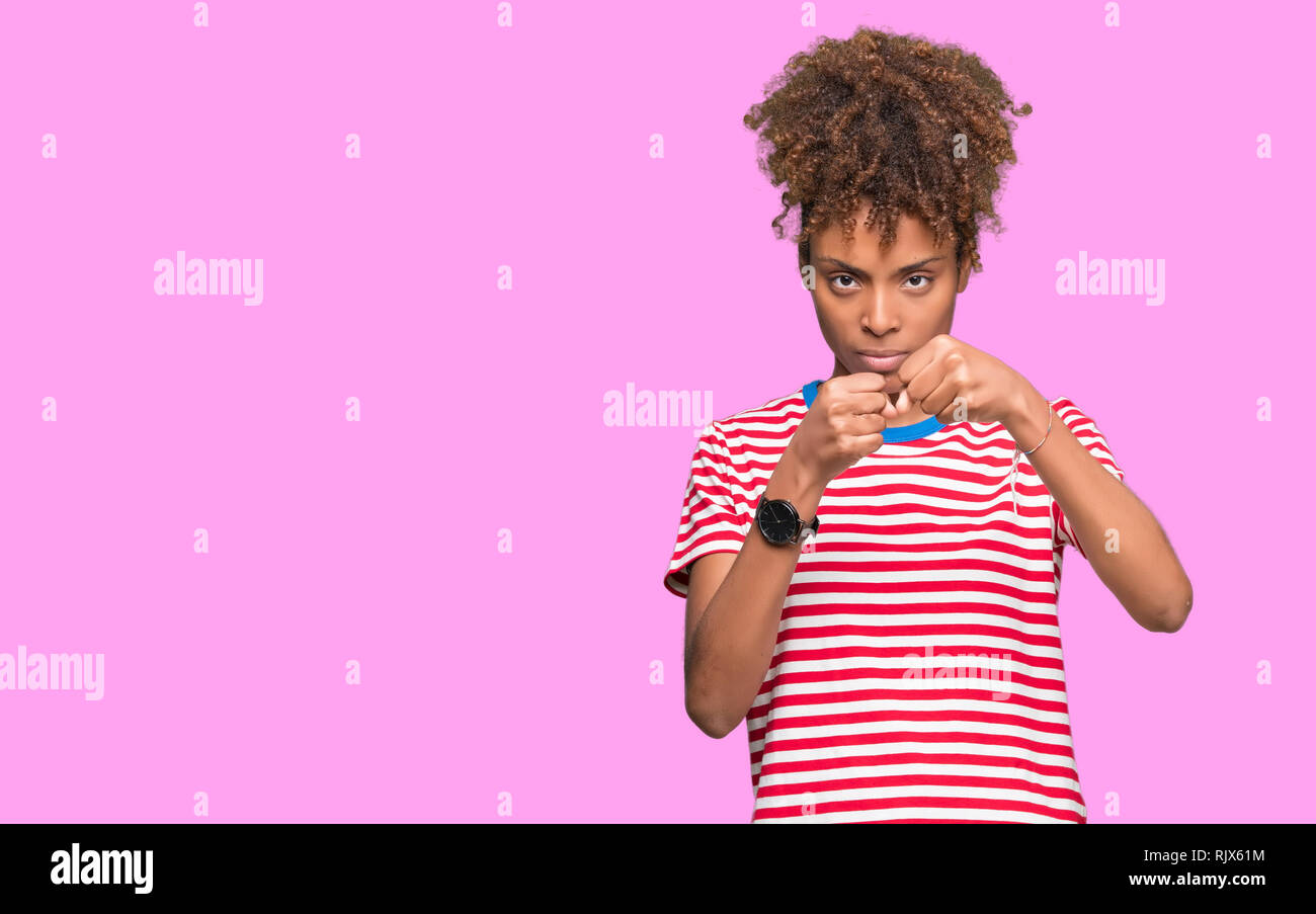 Beautiful young african american woman over isolated background ...