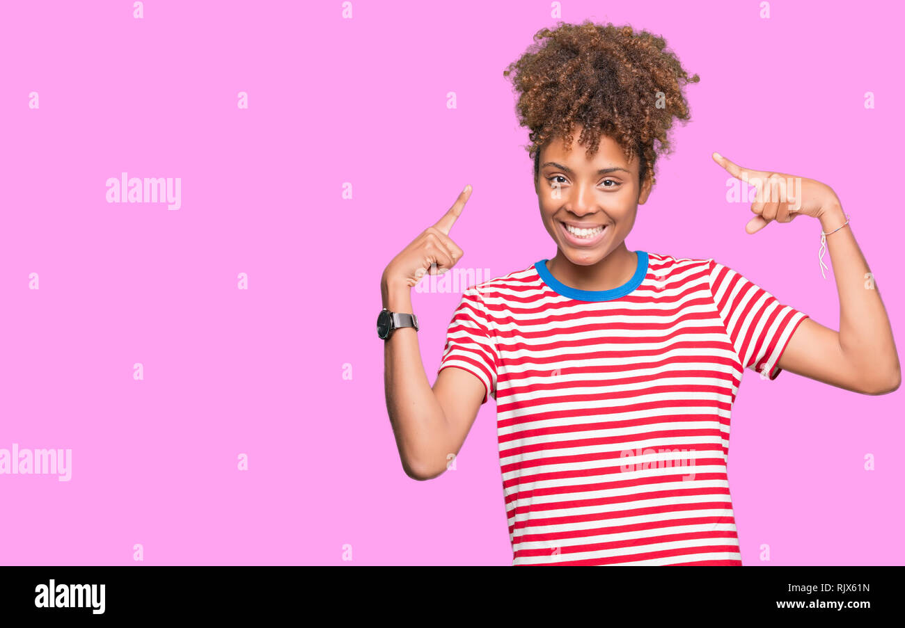 Beautiful young african american woman over isolated background Smiling ...