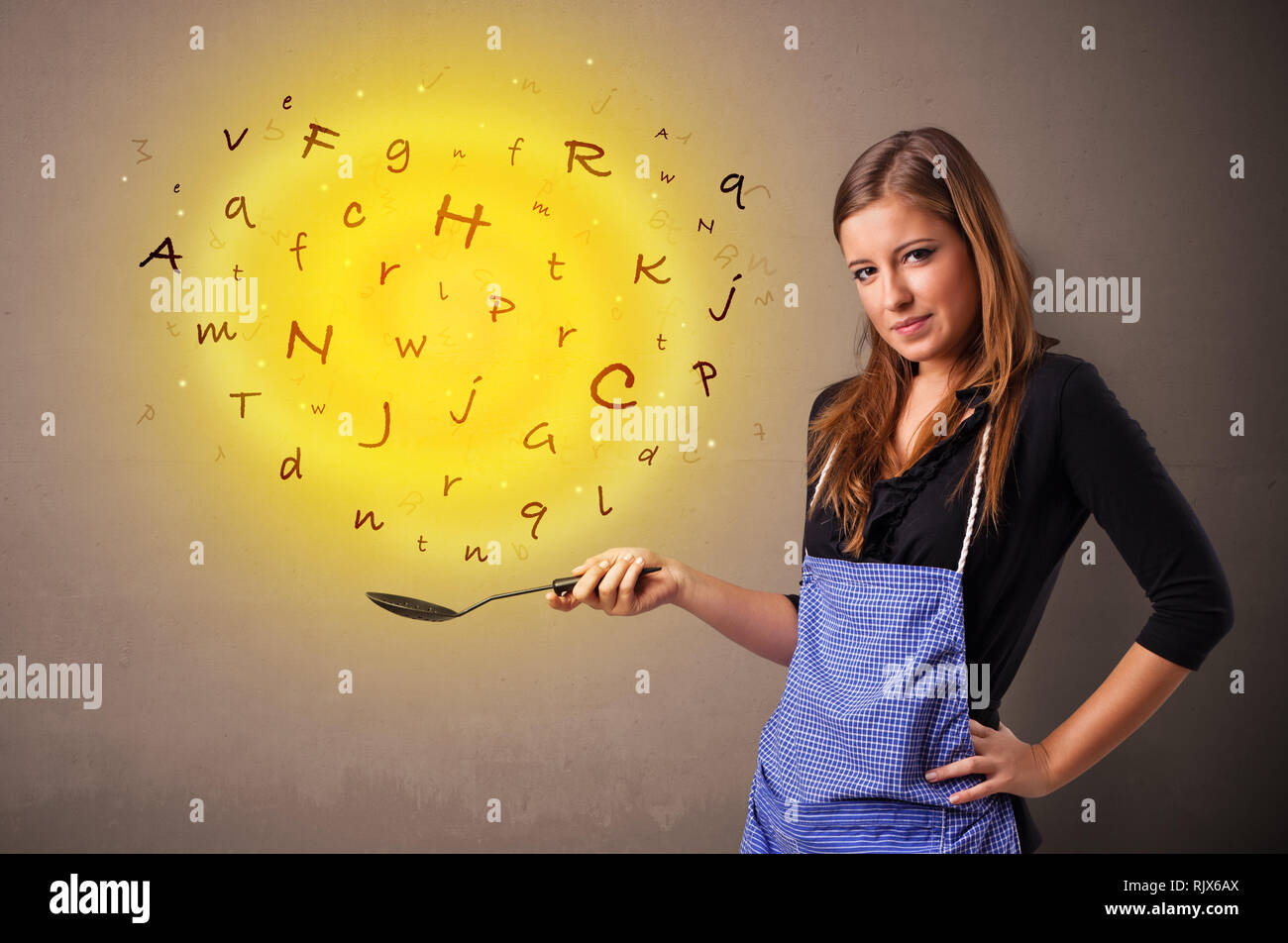 Young person cooking letters in wok Stock Photo - Alamy