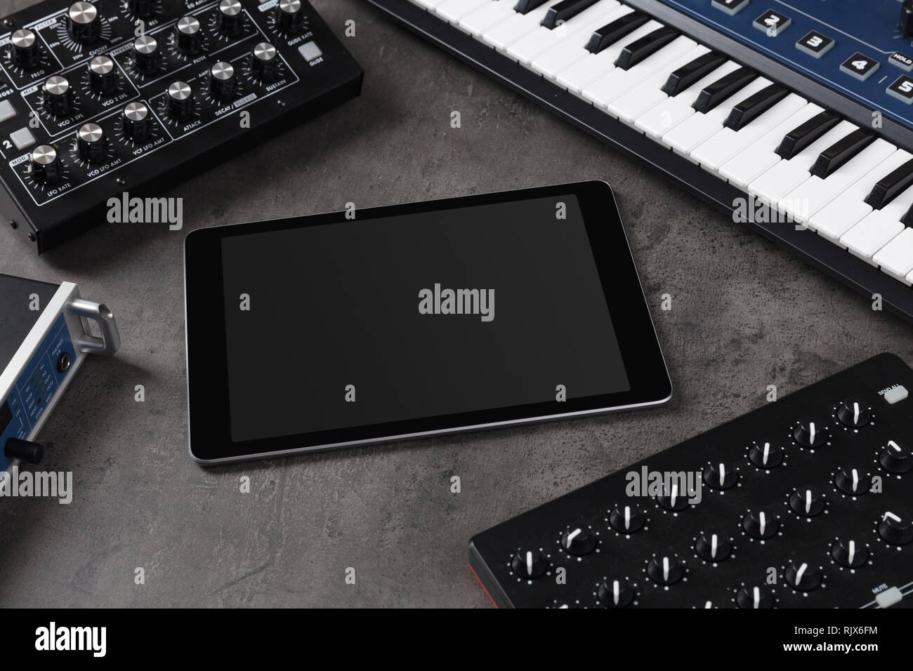 Empty tablet and electronic music instruments Stock Photo - Alamy