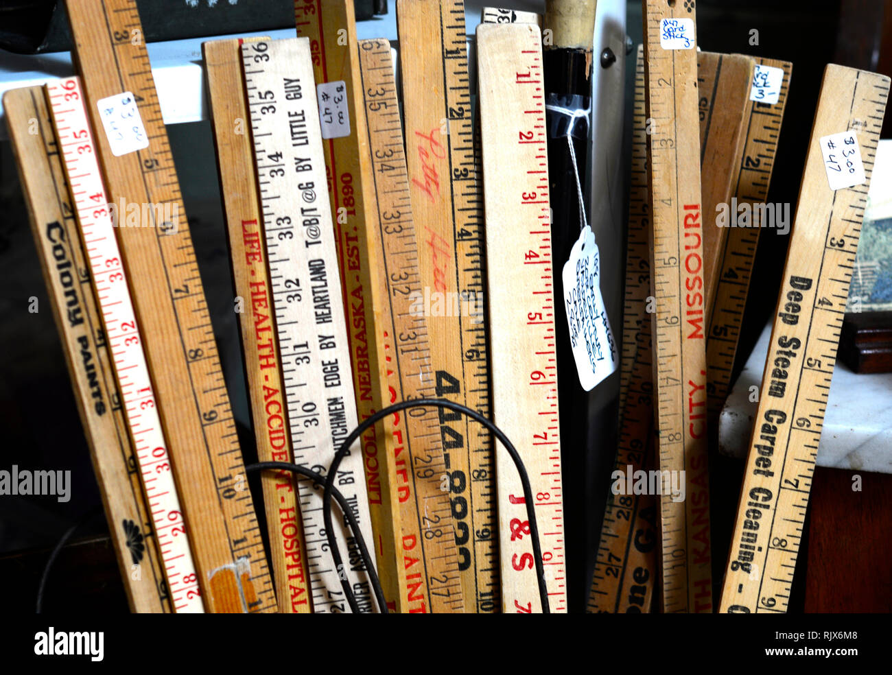 Vintage yardsticks for sale at an antique shop Stock Photo - Alamy
