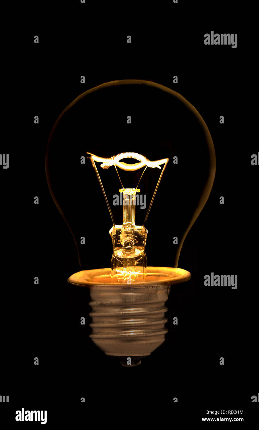 Incandescent light bulb on black background Stock Photo - Alamy