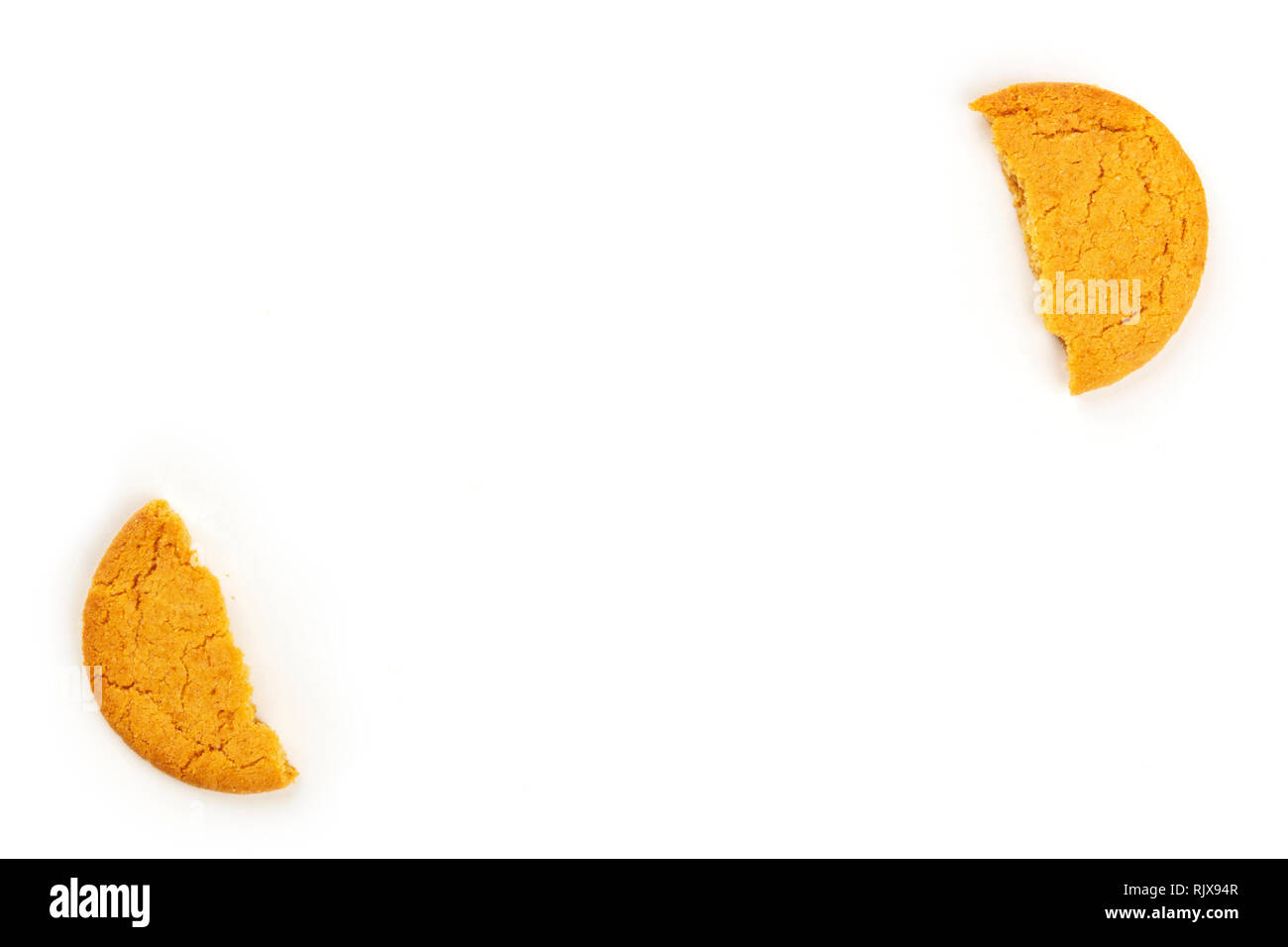 Two halves of a ginger snap cookie forming a frame for copy space, shot ...