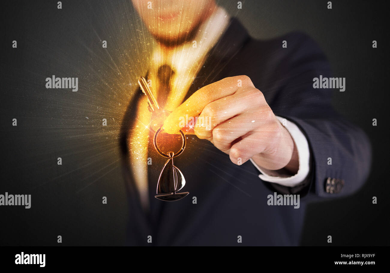 Formal man hand over shiny keys with dark background Stock Photo - Alamy