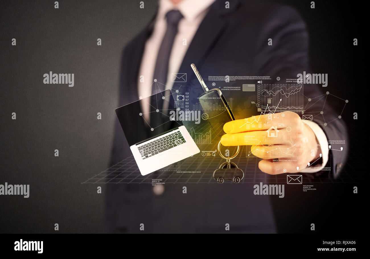 Businessman in suit holding keys with statistics, graphs and icons ...