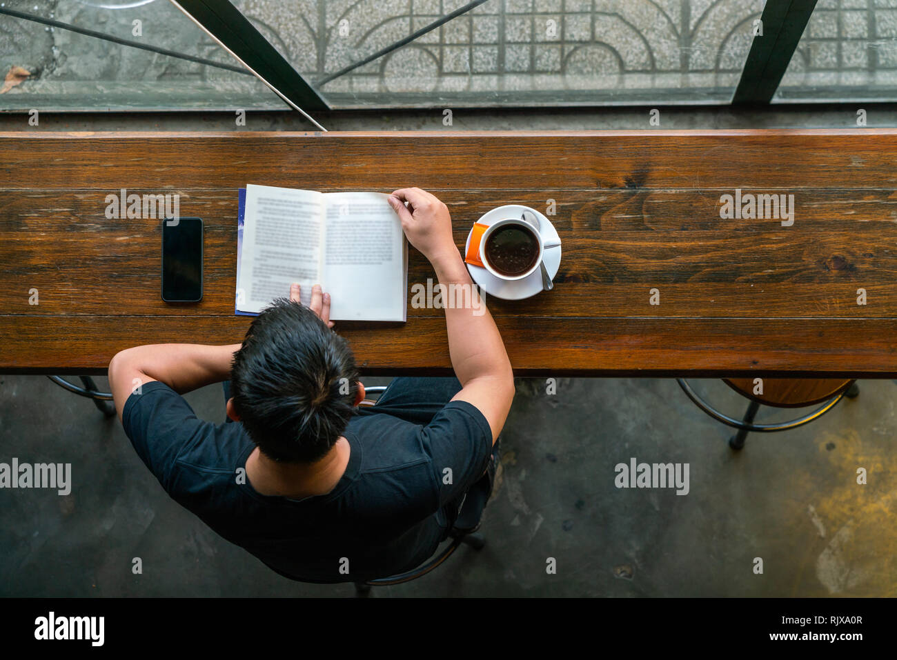 Top view of man reading books Stock Photo - Alamy