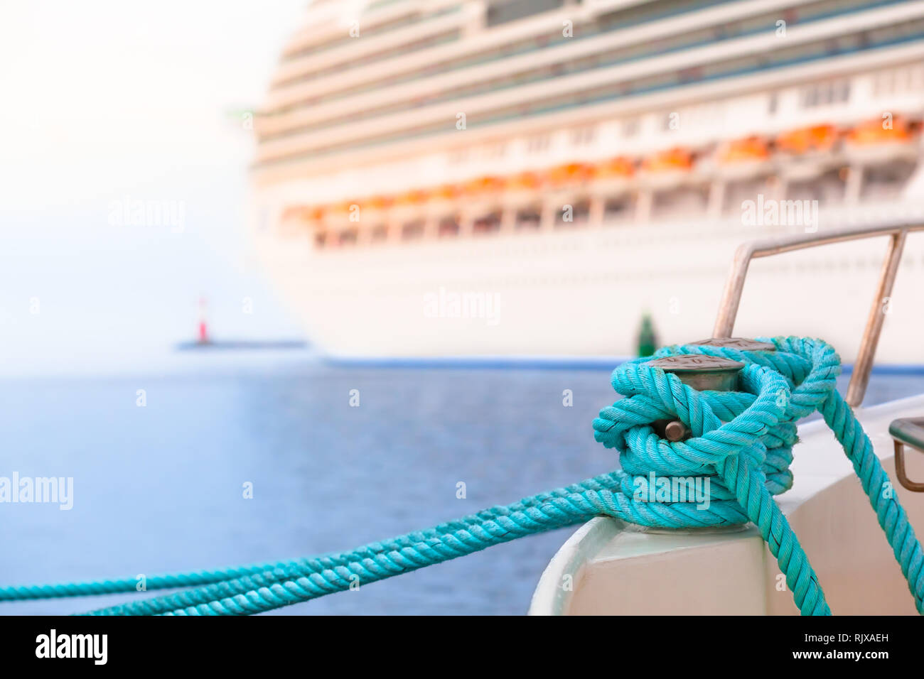 Fixed yacht boat by green rope with knot at bollard in harbor - cruise ...