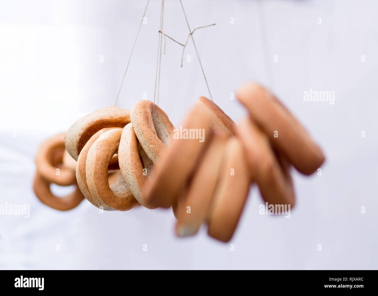 Ring-shaped rolls in a fare for sale on white background, bagels, bread ...