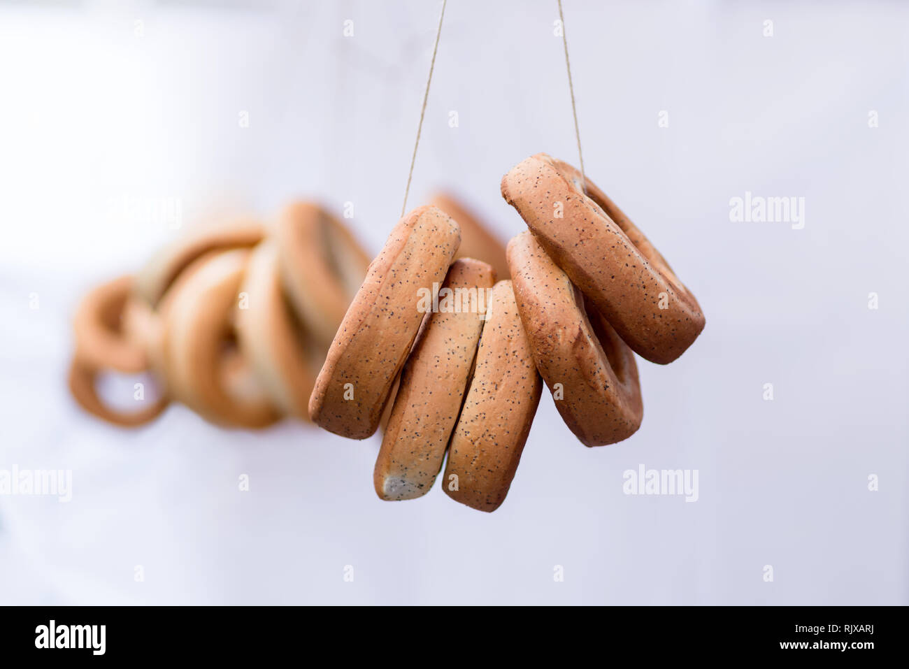 Ring-shaped rolls in a fare for sale on white background, bagels, bread ...