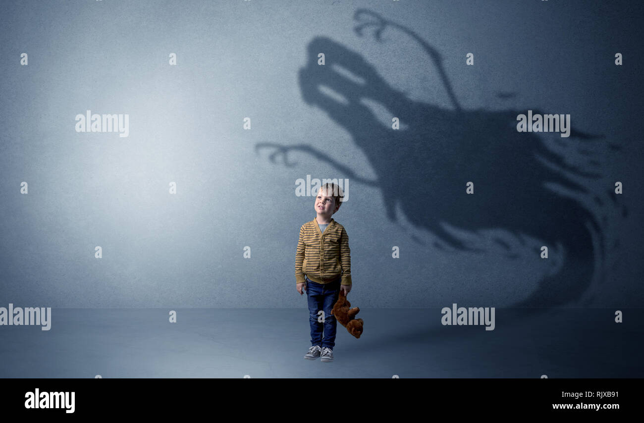 Scary ghost shadow in a dark empty room with a cute blond child Stock ...