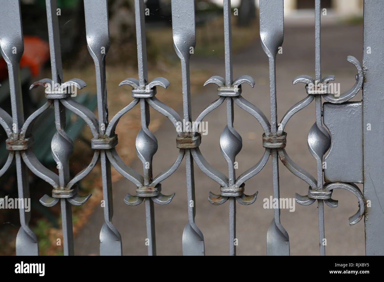 Metal fence. Metal curly fence in the park Stock Photo - Alamy