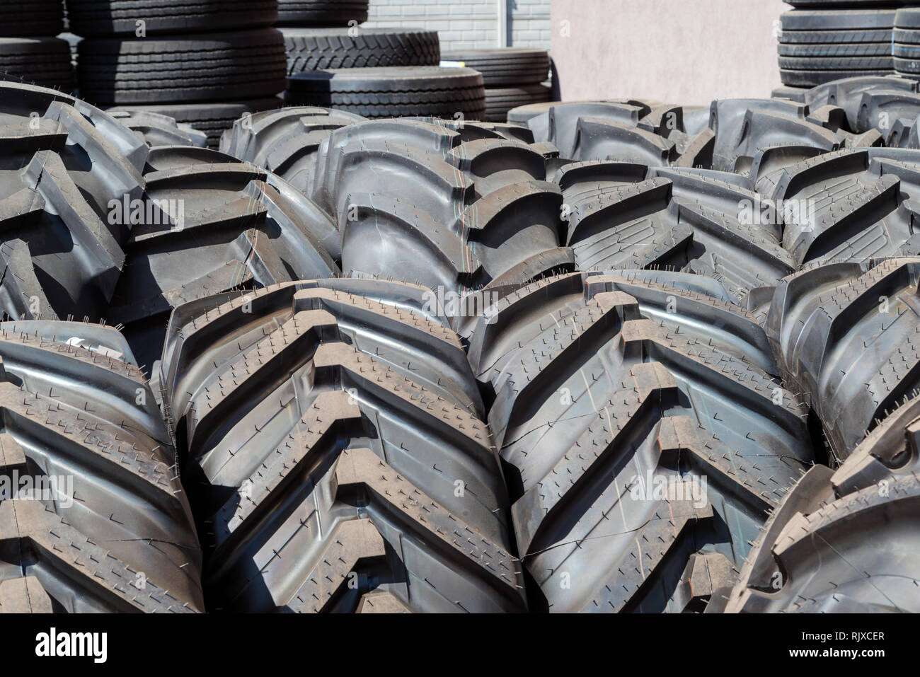 Stack of big car tires outside Stock Photo - Alamy
